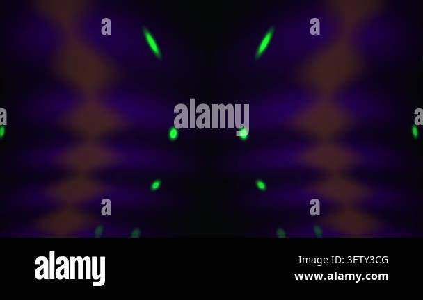 Glowing green particles on dark background with purple and orange hues ...