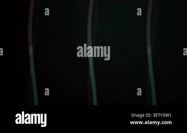 Glowing neon lines on a dark background with colorful bokeh Stock Video ...