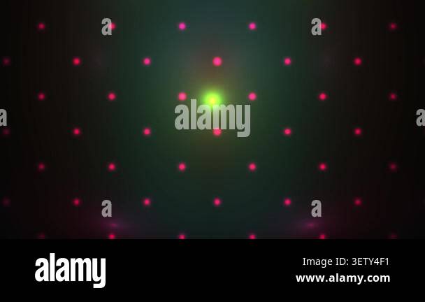 A bright green light shines surrounded by numerous smaller red lights ...