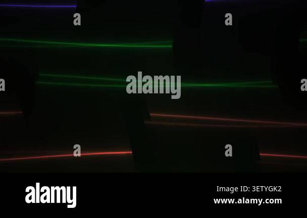 Vibrant neon lights in various colors streak across a dark backdrop ...