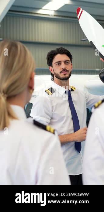 Handsome male flight instructor with a beard explaining aircraft ...