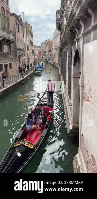 VENICE, ITALY - APRIL 19, 2026: Tourists waving hands from a ...