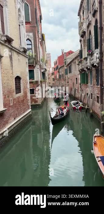 VENICE, ITALY - APRIL 19, 2026: Gondolas with tourists navigating a ...