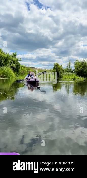 Happy father and daughter in life jacket paddling kayak along narrow ...