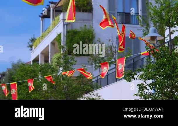 Montenegro national flag strung as festive bunting fluttering outdoors ...