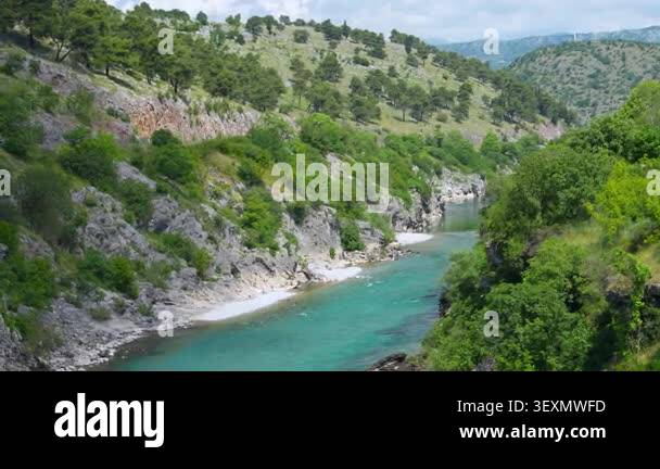 A turquoise river flowing through a deep rocky canyon surrounded by ...