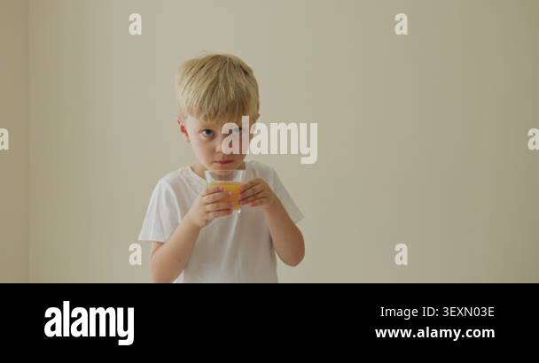 White boy holding orange juice, shy grin, casual white shirt, soft ...