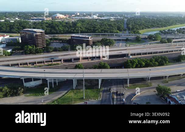 Complex highway systems, elevated train tracks dominate horizon behind ...