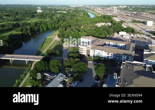 Trinity River flows beneath concrete bridge adjacent to residential ...