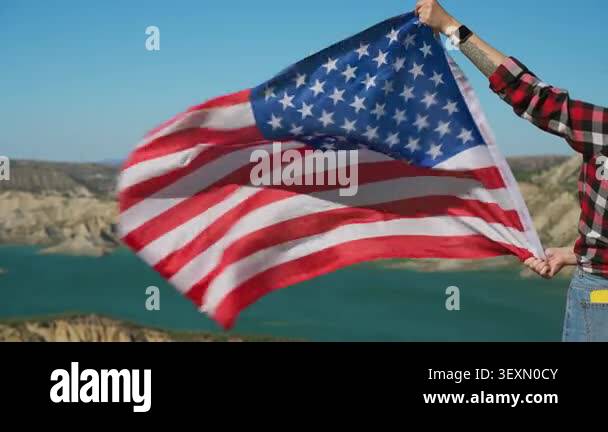 Young woman proudly with American flag enjoy an unforgettable panorama ...