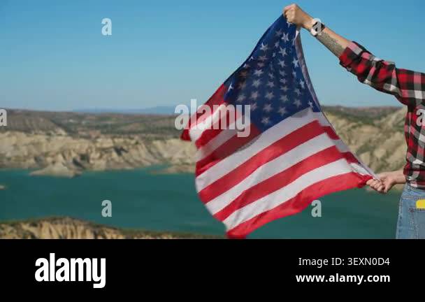 Young woman proudly with American flag enjoy an unforgettable panorama ...