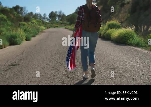 Young woman proudly with American flag enjoy an unforgettable panorama ...