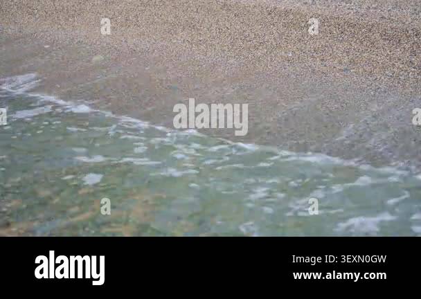 Sand beach, sea water washes over, closeup detail - abstract shallow ...