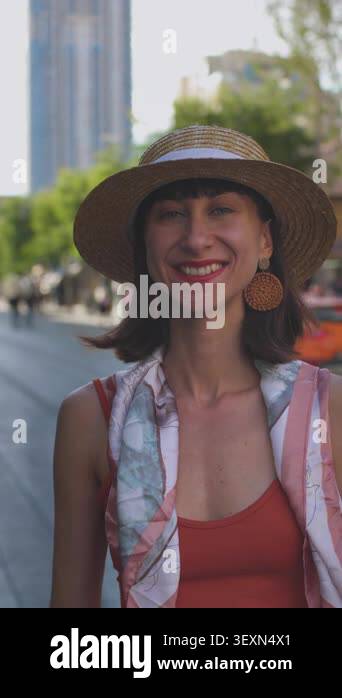 A smiling woman stands in a sunlit town square in Jerusalems Old City ...