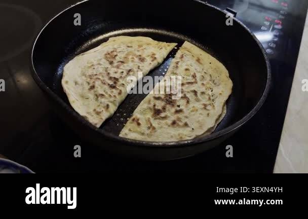 High angle close up view of two half moon shaped qutabs browning in a ...