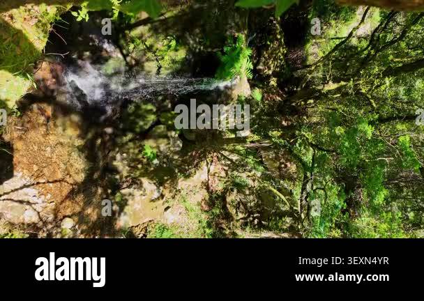 A high angle view captures the Gresso waterfall flowing over textured ...