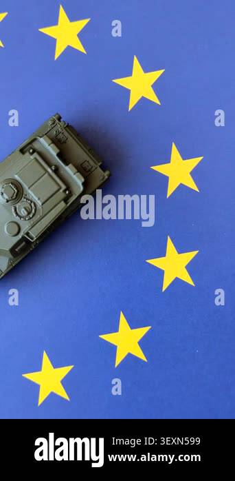 A tank on the European Union flag as a conceptual backdrop representing ...