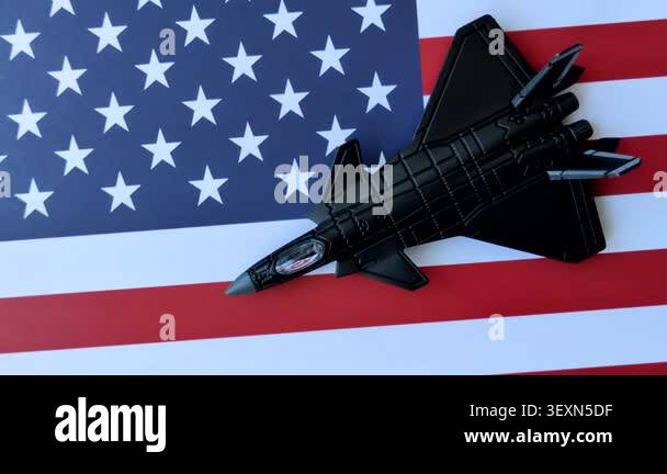 A fighter jet against the US flag as a conceptual background ...
