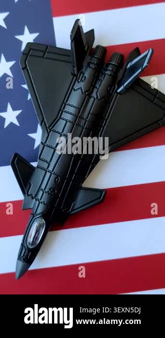 A fighter jet against the US flag as a conceptual background ...