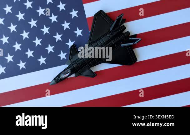A fighter jet against the US flag as a conceptual background ...