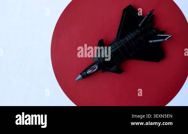 A fighter jet against the Japanese flag as a conceptual background ...