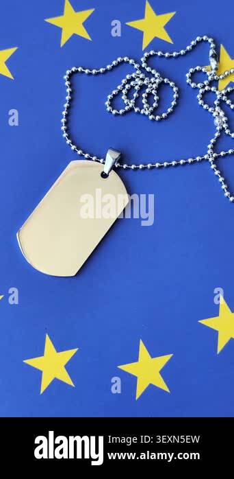A dog tag on the European Union flag, serving as a conceptual backdrop ...