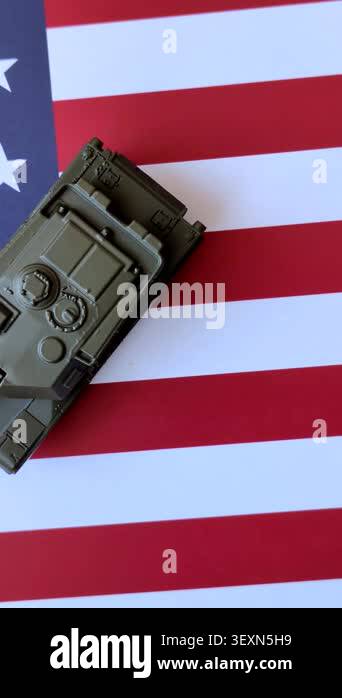 A tank on the US flag as a conceptual backdrop representing defense and ...