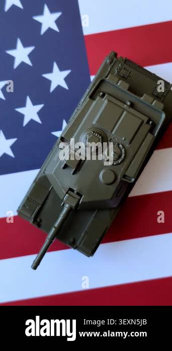 A tank on the US flag as a conceptual backdrop representing defense and ...