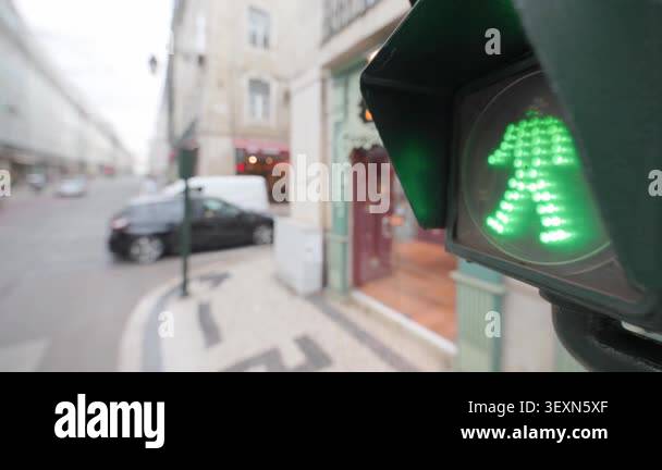 Close up of a traffic signal for pedestrians changing from green to red ...