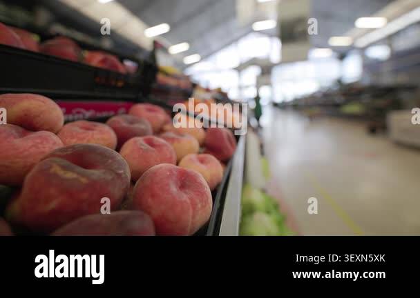 Saturn peaches on display in the produce aisle of a grocery store with ...