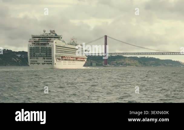 Majestic cruise ship navigating the tagus river with the iconic 25 de ...