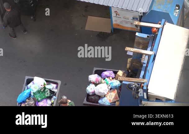 Worker man on Duty with Garbage Containers Near a Truck for Waste ...
