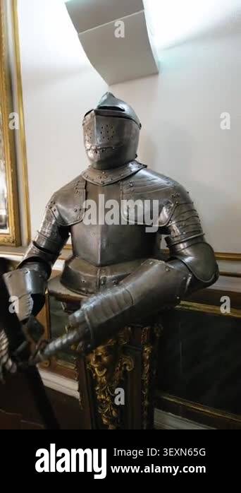 Medieval iron suit of armor with a helmet standing on an ornate ...