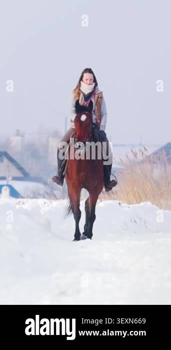 Beautiful longhaired woman riding a brown horse through the deep ...