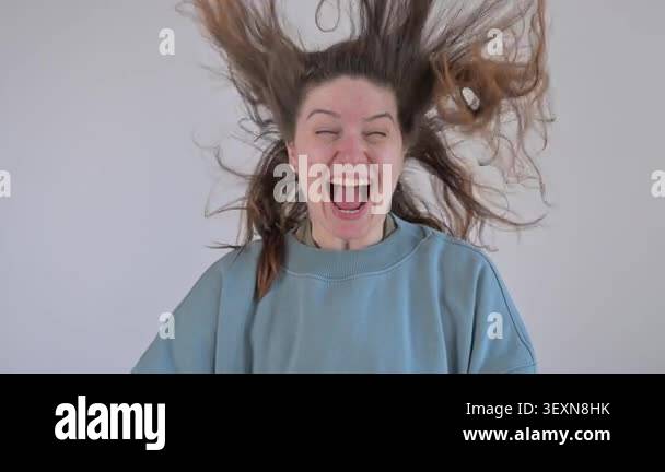 A sharp, strong wind begins to blow on the woman and blows her hair ...