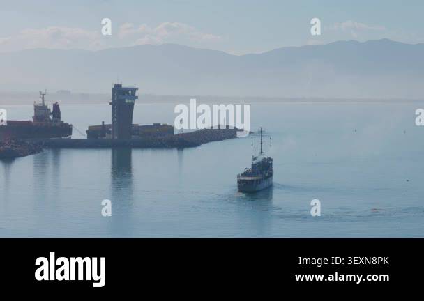 Naval boat arriving past harbor navigation control tower Stock Video ...
