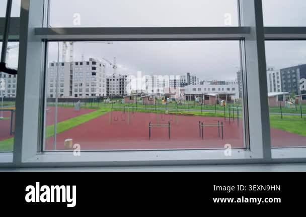 Large glass frame overlooks urban courtyard with various exercise ...