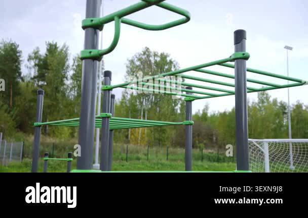 Monkey bars and metal workout frames at sports park. Equipment features ...