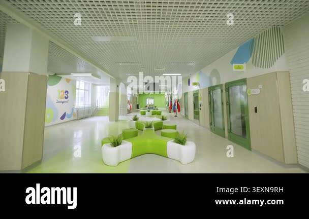 School hallway features modular seating and colorful wall murals ...