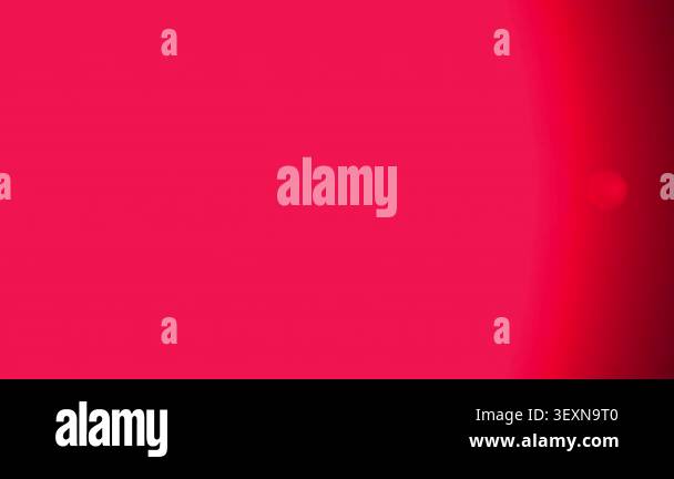 Abstract red light pattern on a dark background with a soft lens flare ...