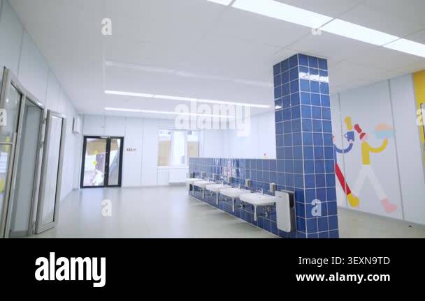 School hall contains handwashing zone with tiles and wall illustrations ...