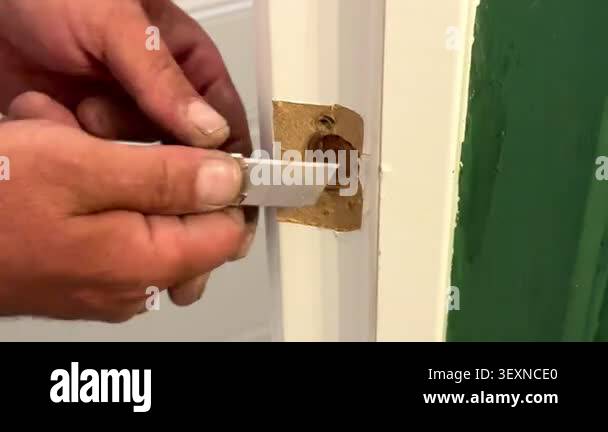 Men's hands repairing a door, door lock Apartment renovation, worker ...