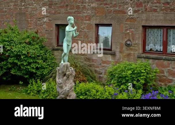 Bronze statue of a boy playing the flute standing on a stone pedestal ...
