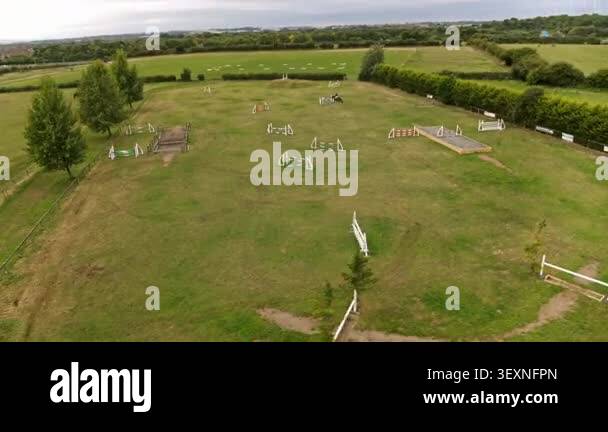 Professional jockey training for a show jumping competition in a green ...