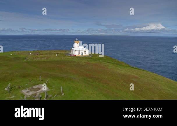Aerial view flying towards Duncansby Head lighthouse on a cliff ...