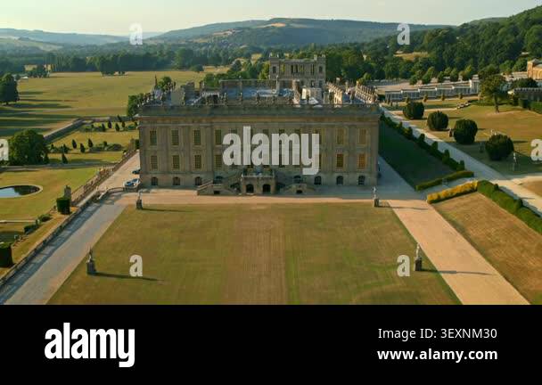 Backward aerial drone shot of the historic Chatsworth House and its ...
