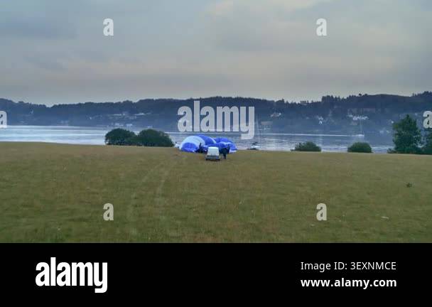 Hot air balloon envelope deflating on a green grassy field after ...