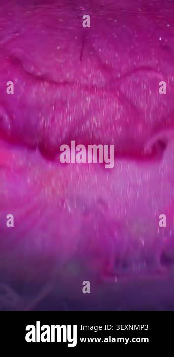 Vertical video. Pigment fluid drip. Defocused swirl. Glitter pink ...