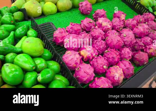 Vibrant Tropical Fruit Display at Indoor Market. Pan shot of colorful ...