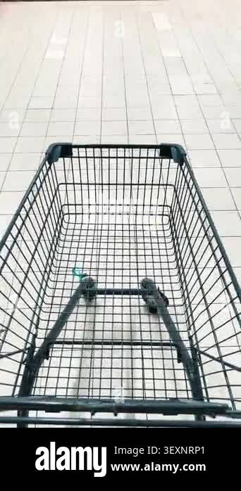 First-person view of pushing an empty shopping cart across a tiled ...